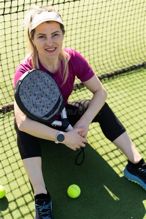 Sporty European Woman Padel Tennis Player Trains On The Outdoor Court