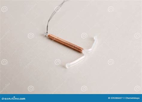 Copper Intrauterine Contraceptive Device On Light Background Stock