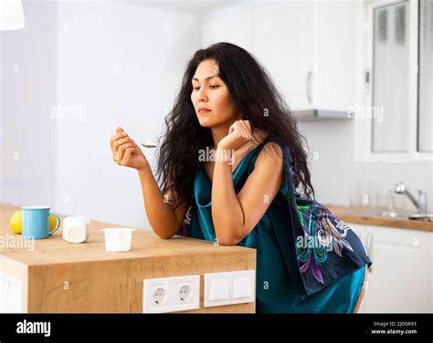 Portrait Of Woman Eating Yoghurt At Home Stock Photo Alamy