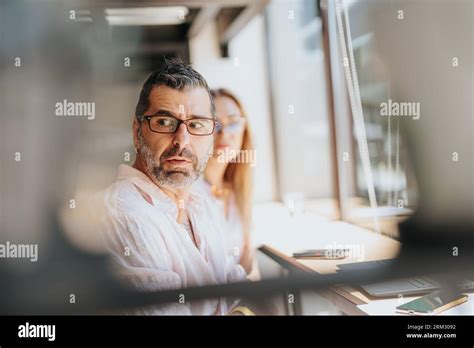 Analyzing Discussing And Working Together A Diverse Group Of Business Professionals In A