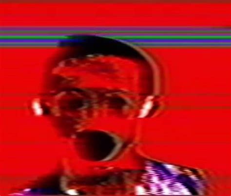 A Man With Headphones On In Front Of A Red And Blue Background That Has