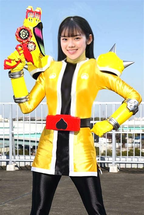 A Woman In A Yellow And Black Outfit Holding A Pair Of Red Gloves On