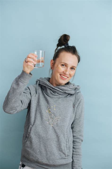Portrait Of A Beaming Woman Raising A Glass Of Water Stock Image