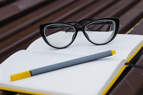 Premium Photo Glasses For Vision On A Notepad With A Marker Study Concept