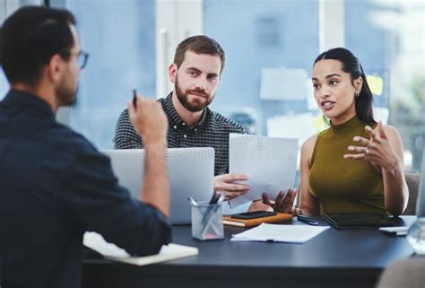 Everything They Do Is Rooted In Innovation A Group Of Young Designers Having A Discussion In An