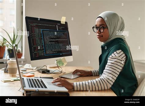 Side View Of Young Intern Or Professional Software Developer Touching