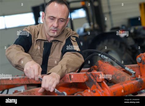 Man Fixing Tractor Stock Photo Alamy