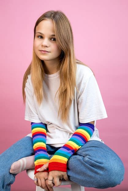 Premium Photo A Pensive Young Girl Sits On A White Chair Pink Background