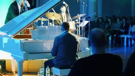 Premium Photo A Man Playing Piano At The Concert And The Audince
