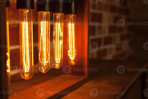 Light Bulb Lamp On Dark Red Brick Background With Hotspot Close Up Loft Stock Photo At