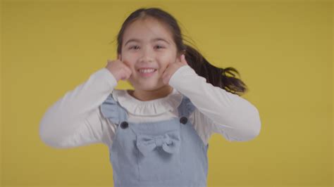 Free Stock Video Studio Portrait Of Hyperactive Girl Smiling And