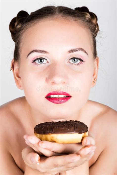 Girl In Bright Makeup Eating A Tasty Donut With Icing Funny Joyful