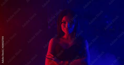 A Beautiful Girl Is Posing And Looking At The Camera And Sexually Raising Her Hand To Her Face