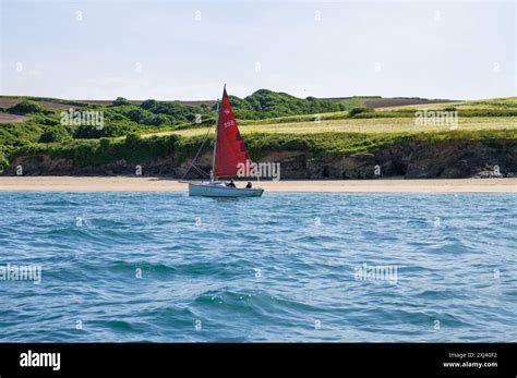 Man And Woman Sailing Small Boat Under Aft Rigged Mainsail On The Camel Estuary Near Padstow