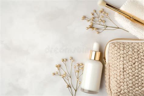 A Serene Arrangement Features A Glass Serum Bottle Beside A Soft Towel