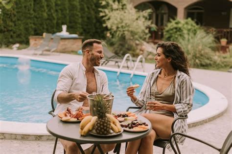 Premium Photo Young Couple Sitting In The Backyard