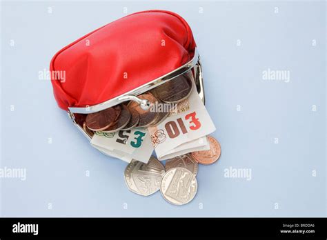 Studio, still life, UK, Europe. Red money purse containing ten and ...