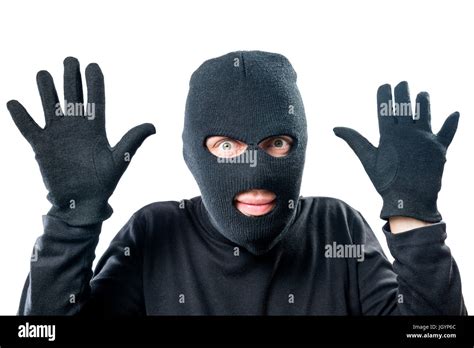 Robber In Black Protective Clothing With Hands Up Close Up Portrait