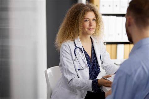 Premium Photo Female Doctor And Male Patient Discussing Current