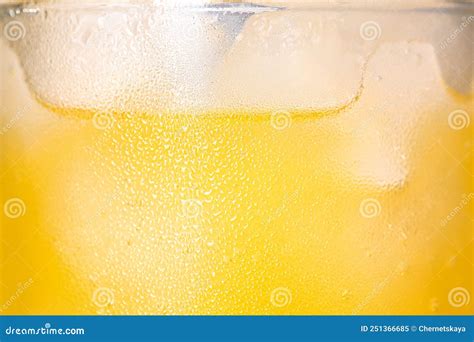 Glass Of Refreshing Drink With Ice Cubes On Light Background Closeup