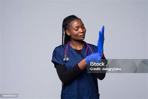 백인 배경에 고립 된 일회용 장갑을 착용한 의료 얼굴 마스크를 착용한 아프리카 계 미국인 간호사 또는 의사 여성 간호사에 대한