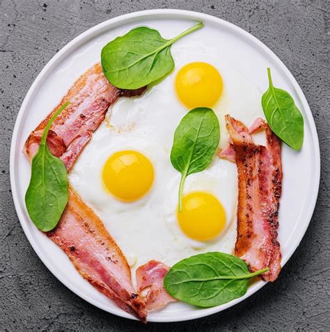 Premium Photo Fried Eggs And Bacon For Breakfast On A Plate