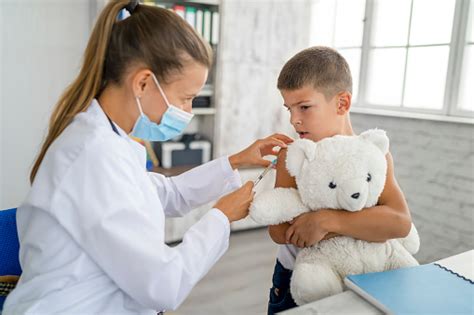 의사의 사무실에서 예방 접종을받고 사랑스러운 어린 소년의 초상화 부상에 대한 스톡 사진 및 기타 이미지 부상 소아과 의사 코로나바이러스 Istock