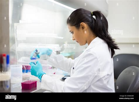 Closeup Portrait Scientist Holding 50 ML Conical Tube With Blue Liquid Solution Performing
