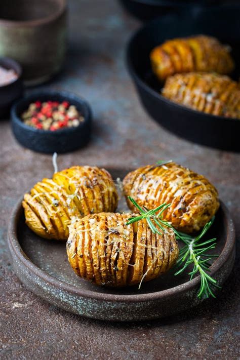 Baked Hasselback Potato With Cheddar Cheese And Rosemary Stock Image
