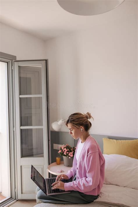 In Full Growth Young Caucasian Girl With Wireless Headphones Sitting On