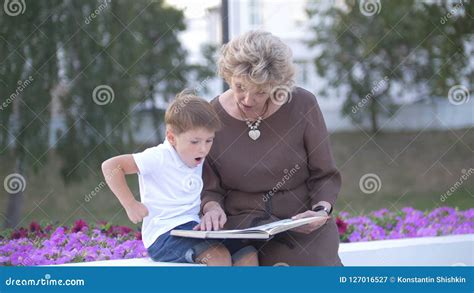 Grandmother With Grandson Reading A Book Together Stock Image Image