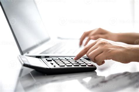 Woman Hand Using Calculator And Laptop 3219831 Stock Photo At Vecteezy