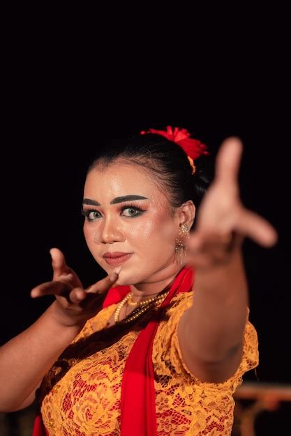Premium Photo A Balinese Woman Poses With Both Her Hands In A