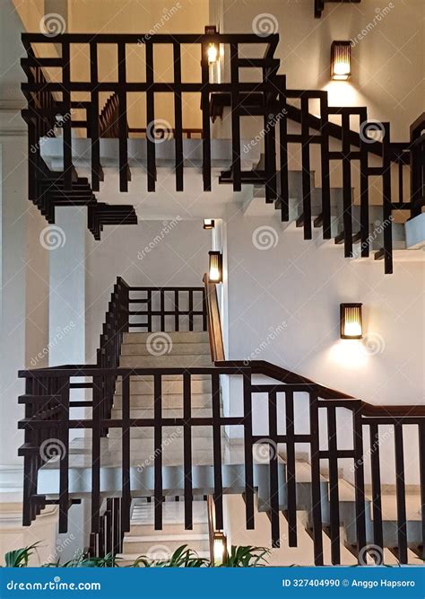 Classic Style Wooden Staircase Handrail Lightened By Wall Lamp Stock