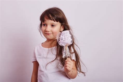 Premium Photo Beautiful Girl With Blond Hair Eats A Lollipop Round