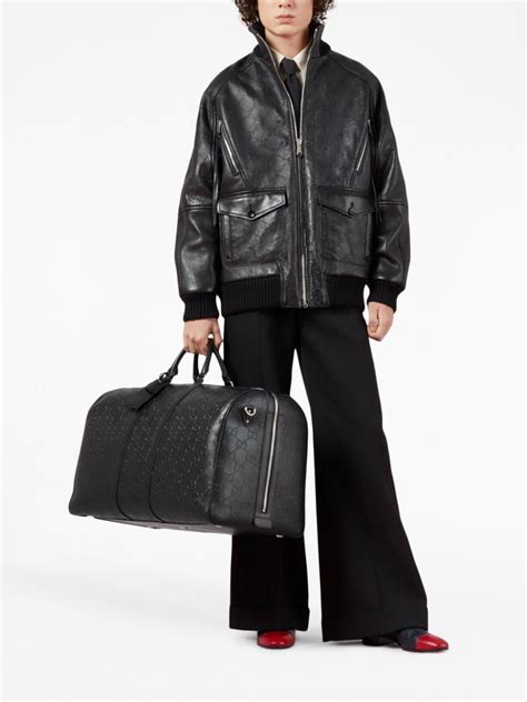 Gucci Gg Embossed Leather Duffle Bag In Black Modesens