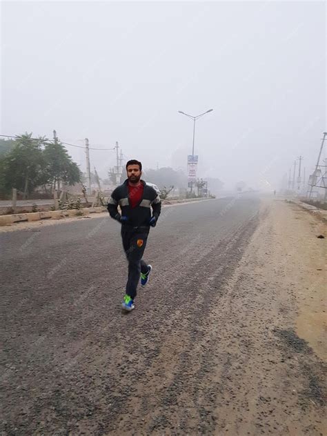 Premium Photo Man Running On Road During Foggy Weather