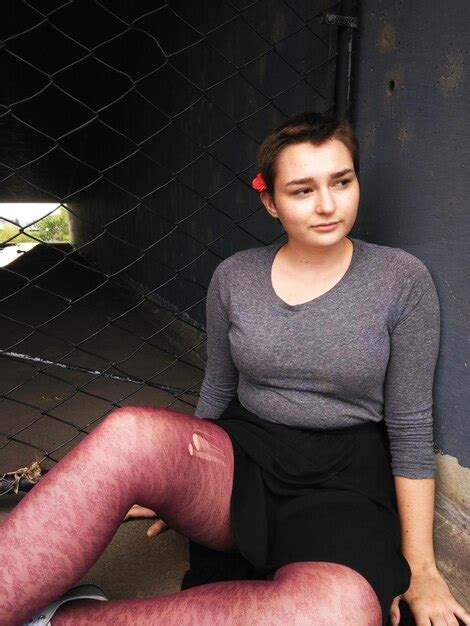 Premium Photo Teenage Girl Looking Away While Sitting Against Wall