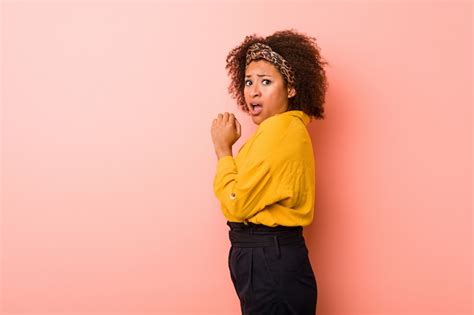 Premium Photo Young African American Woman Against A Pink Wall Scared