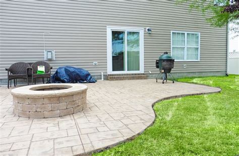 Outdoor Living With Fire Pit On Stamped Concrete Patio