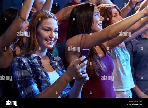 Woman With Smartphone Texting Message At Concert Stock Photo Alamy