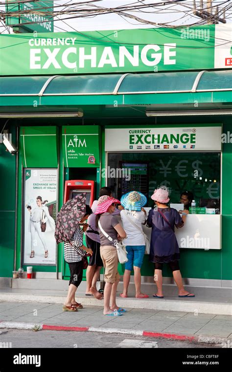Tourists Changing Money At A Currency Exchange Booth On Bangla Road On