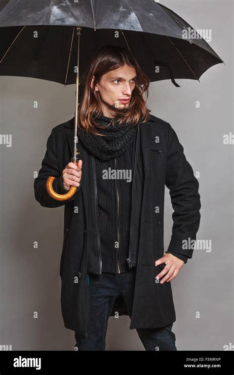Portrait Of Handsome Fashionable Man Wearing Black Coat And Scarf