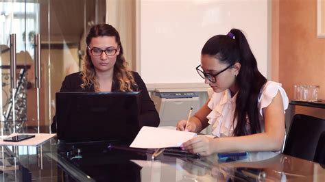 Two Business Beautiful Business Women Wearing Glasses In Business