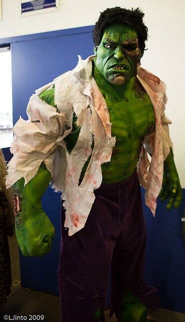 A Man Dressed As The Incredible Hulk In An Office Cubicle With His