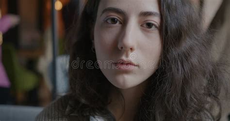 Slow Motion Portrait Of Pensive Young Lady With Wavy Hair Sitting In