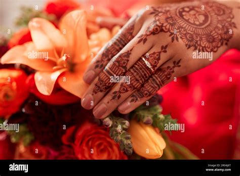 Bridal Henna Goals An Unrecognizable Woman Holding A Bunch Of Flowers