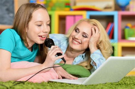 Mother And Daughter Singing Karaoke Stock Image Colourbox