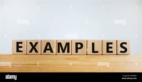 Examples Symbol Concept Word Examples On Wooden Cubes On A Beautiful