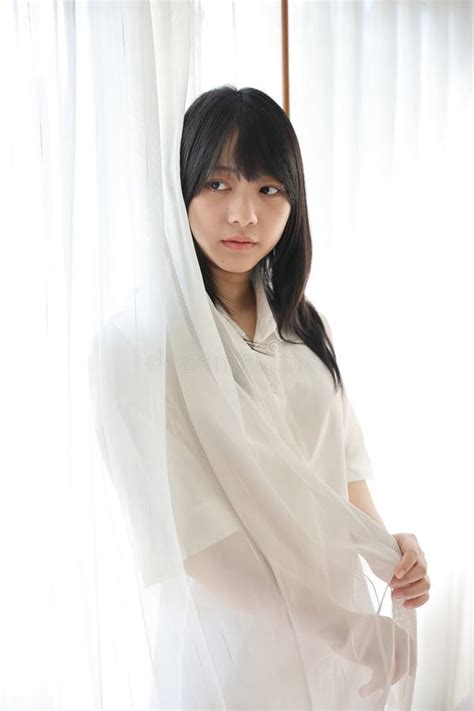 Beautiful Young Woman Waking Up In The Morning At White Bedroom Stock